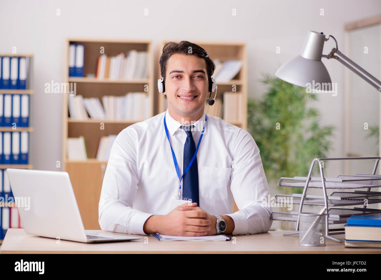 Handsome customer service clerk with headset Stock Photo - Alamy
