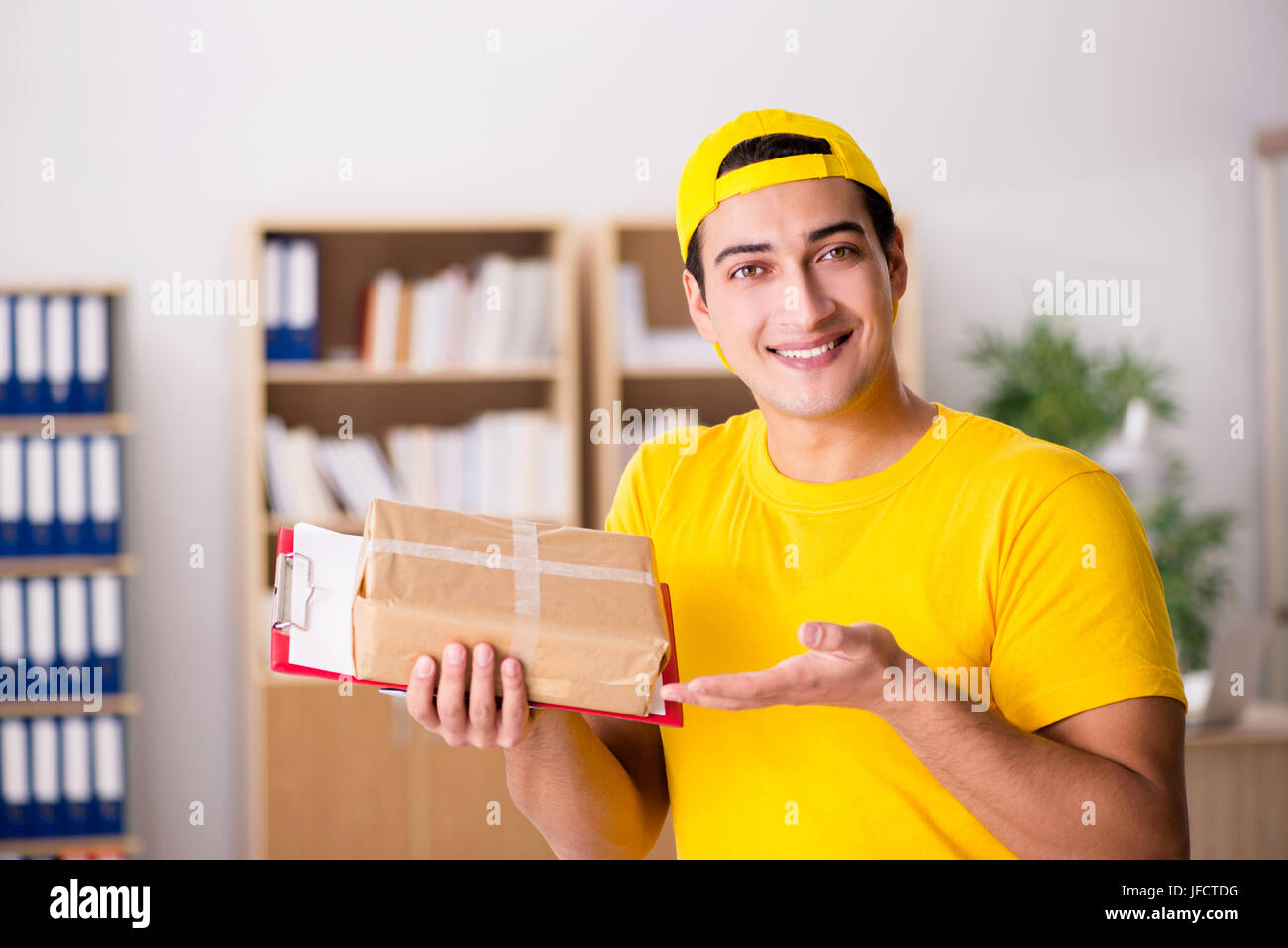 Delivery man delivering parcel box Stock Photo - Alamy
