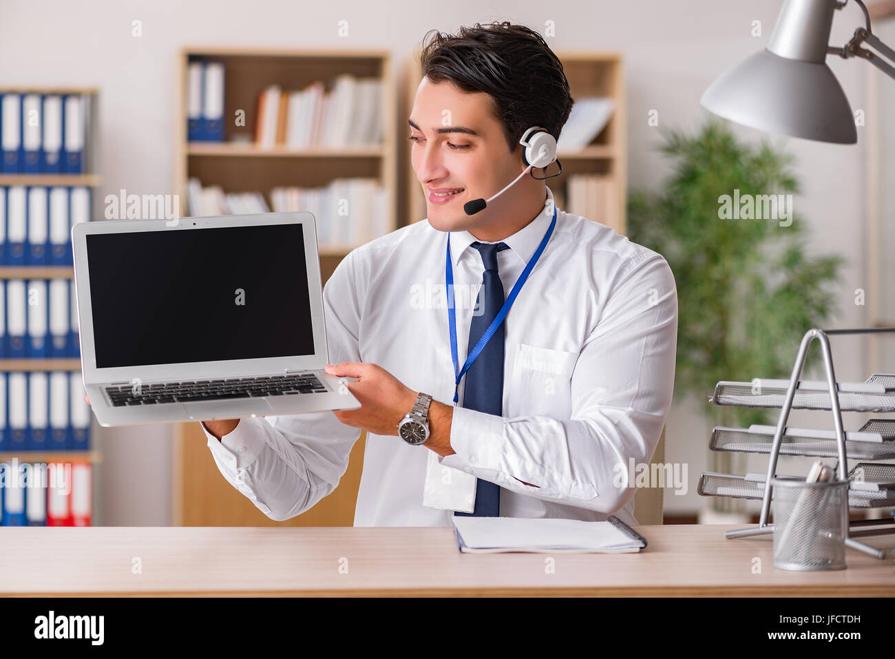 Handsome customer service clerk with headset Stock Photo - Alamy