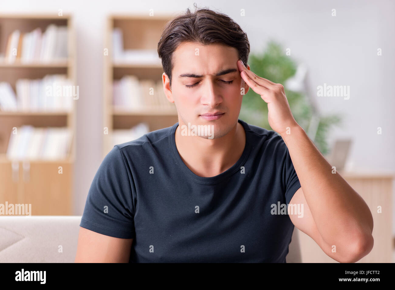 Young handsome man suffering from pain Stock Photo - Alamy