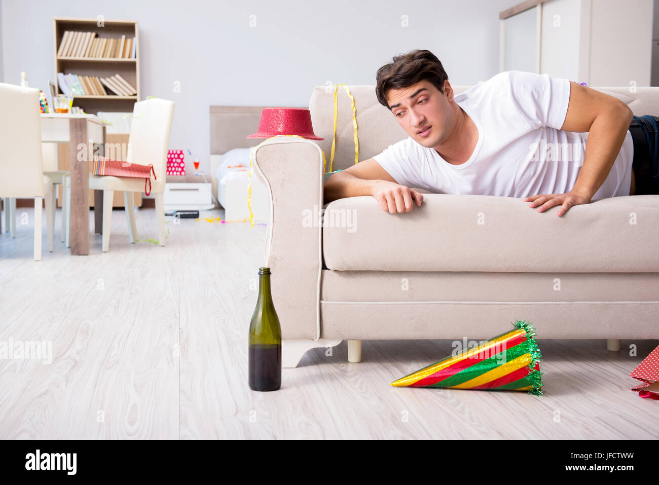 Man at home after heavy partying Stock Photo - Alamy