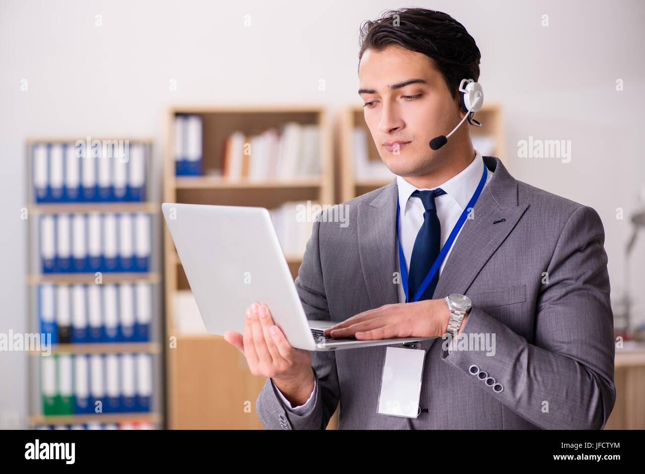 Handsome customer service clerk with headset Stock Photo - Alamy