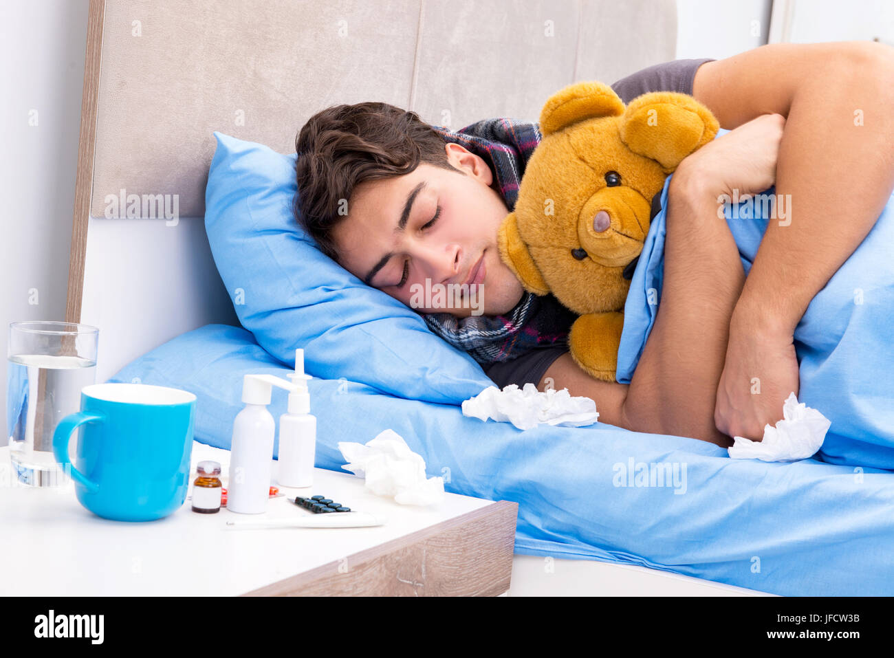Sick man with flu lying in the bed Stock Photo - Alamy