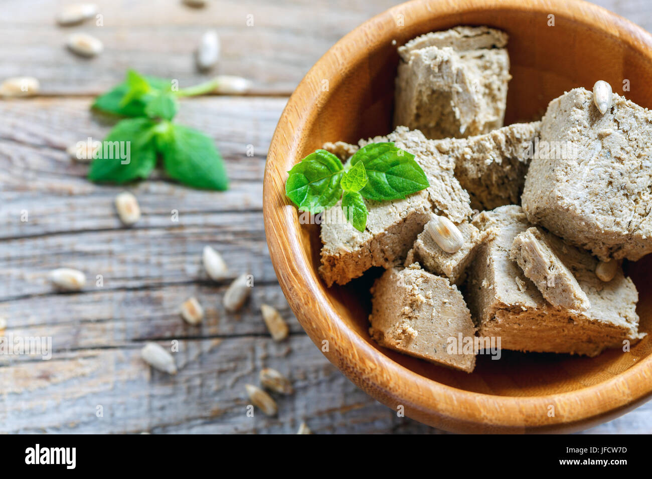 Halva from sunflower seeds in a wooden bowl Stock Photo - Alamy