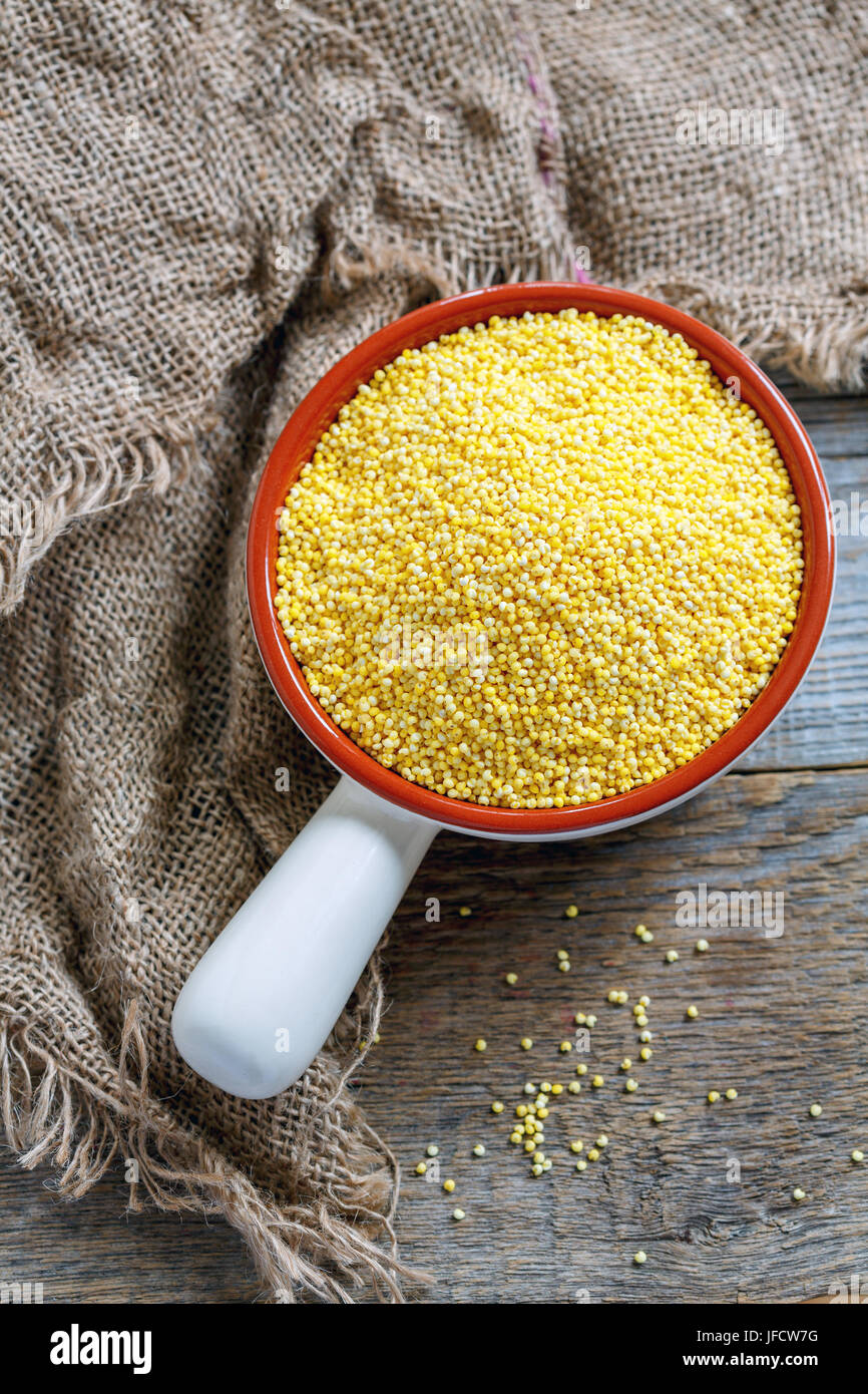 Raw millet in a ceramic bowl Stock Photo - Alamy