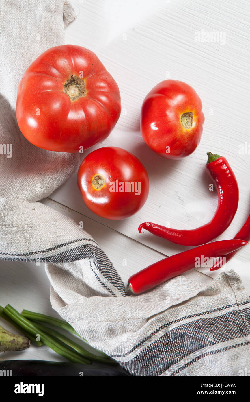 Tomatoes "bull heart" on a wooden white table. Autumn harvest. Recipes ...