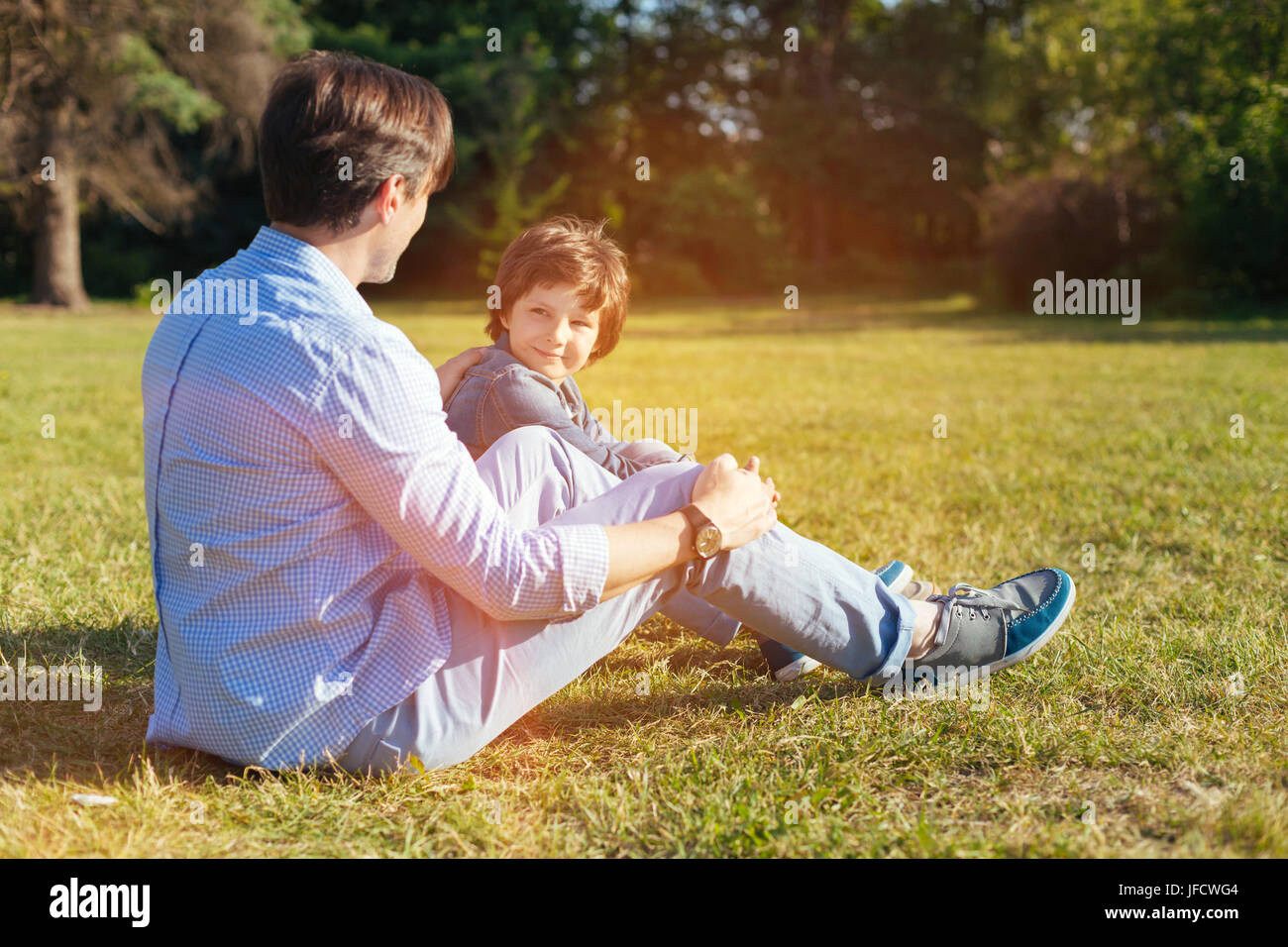 Mens conversation. Charming cheerful wonderful kid and his dad sitting ...