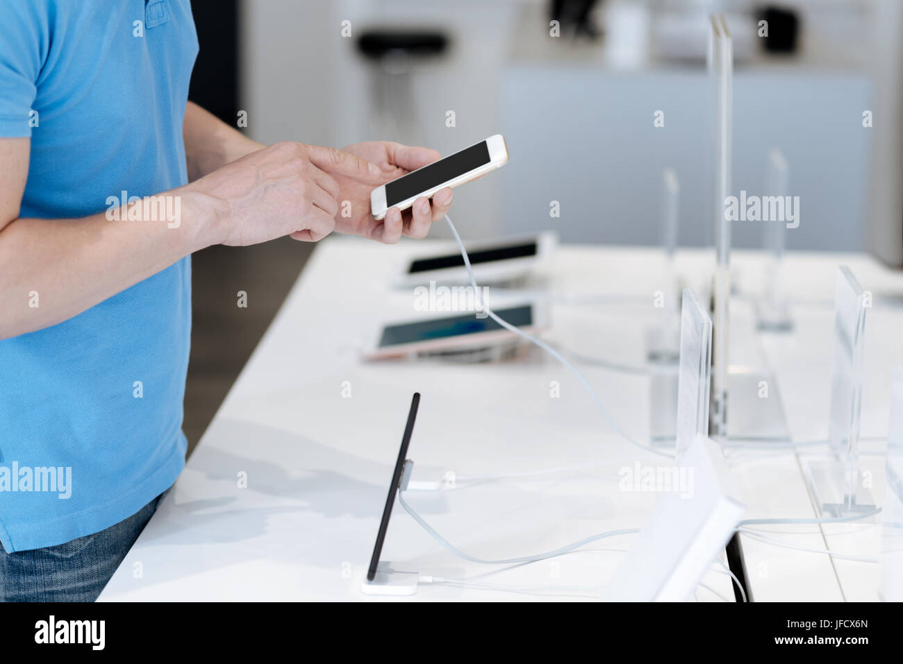 Let me try it out. Scaled up shot of a male customer standing at a ...