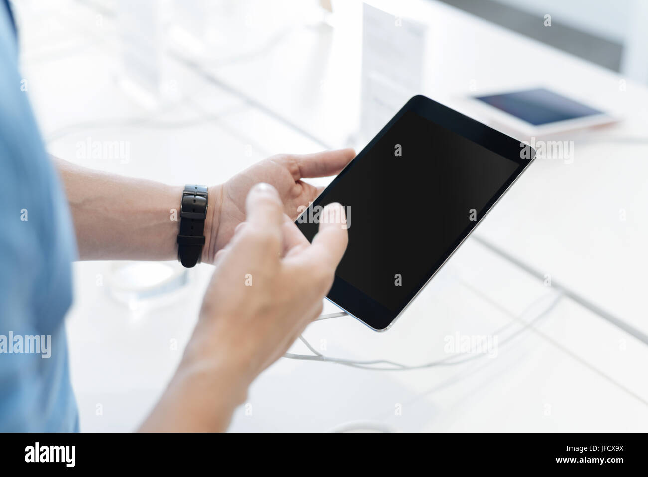 it impresses me with every touch. Scaled up shot of a male shopper ...