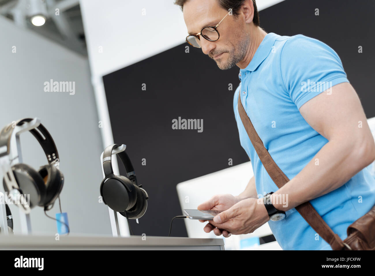 These are quite good. Focused adult customer standing at a display and ...