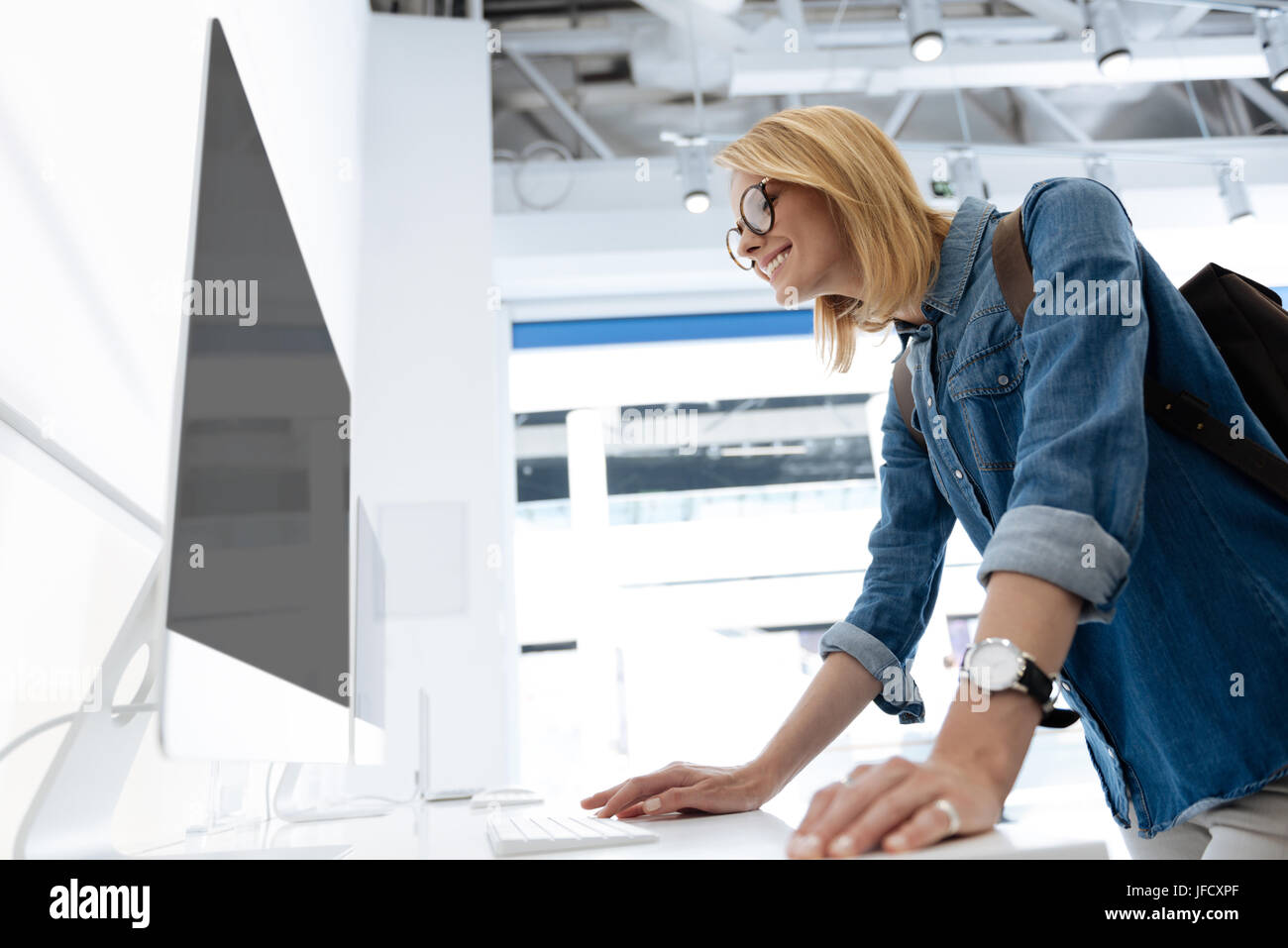 it looks impressive. Side view of a female customer standing at a store ...