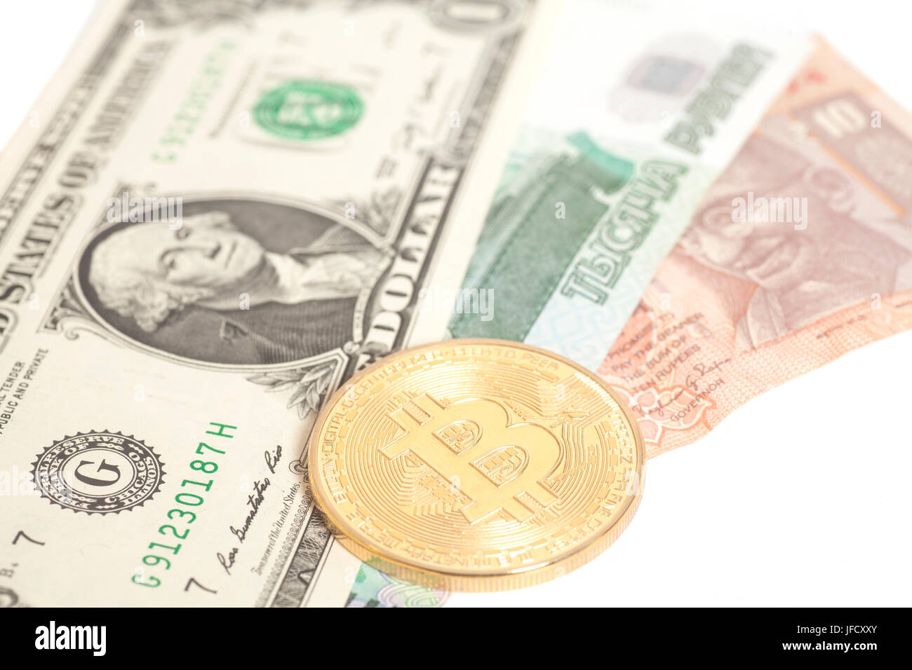 Golden bitcoin with U.S. dollar,ruble end rupee banknotes isolated on ...
