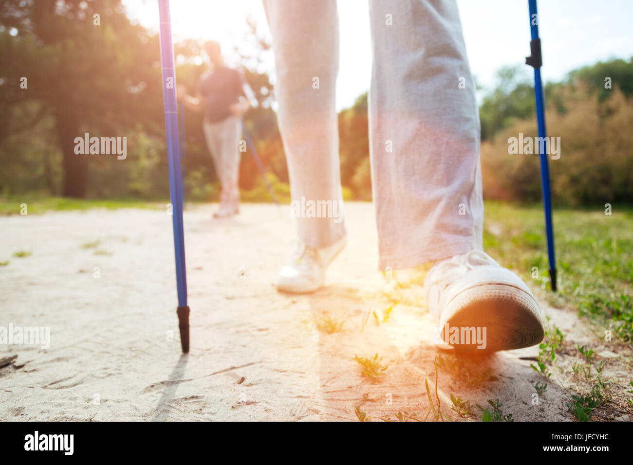 Movement is life. Nice active aged man holding walking poles and making ...
