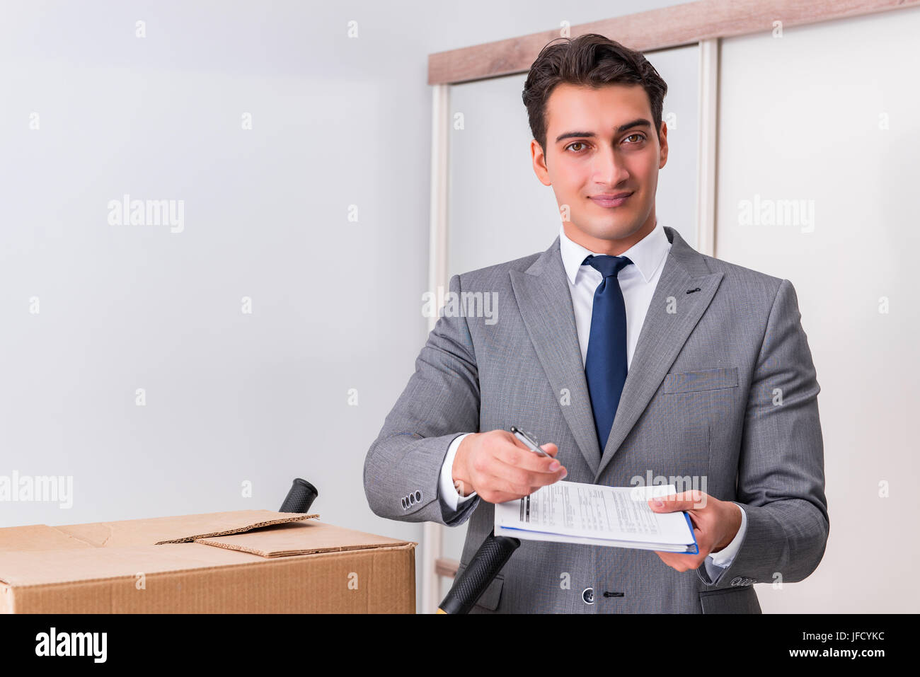 Man signing for the delivery of boxes Stock Photo - Alamy
