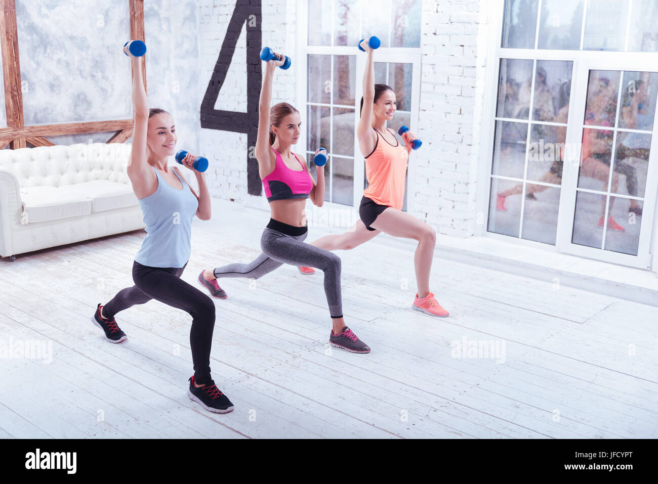 Full body workout. Top view of pretty young woman standing and doing ...