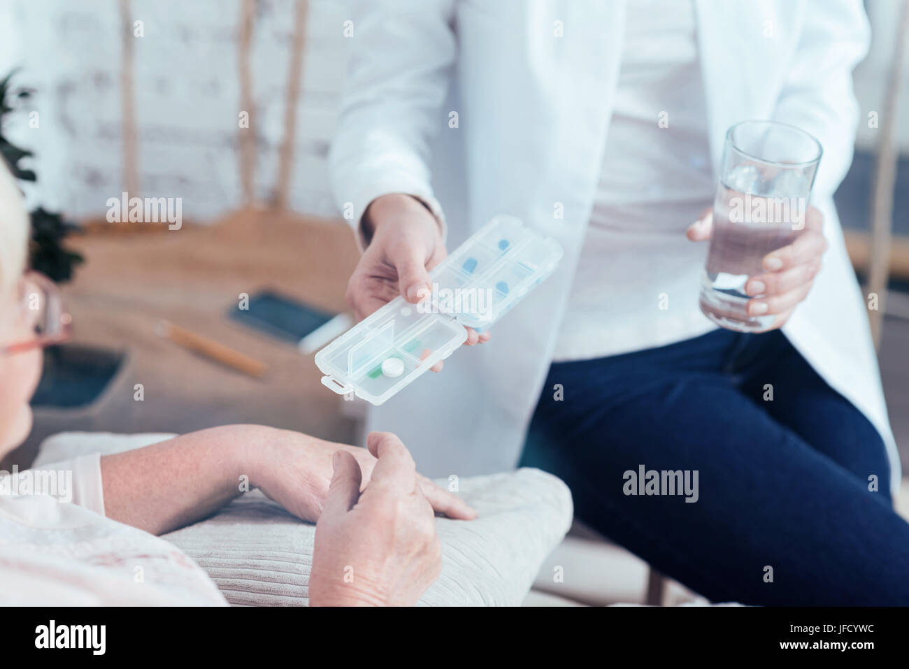 Helping needy aged people . Friendly proficient medical doctor sitting ...