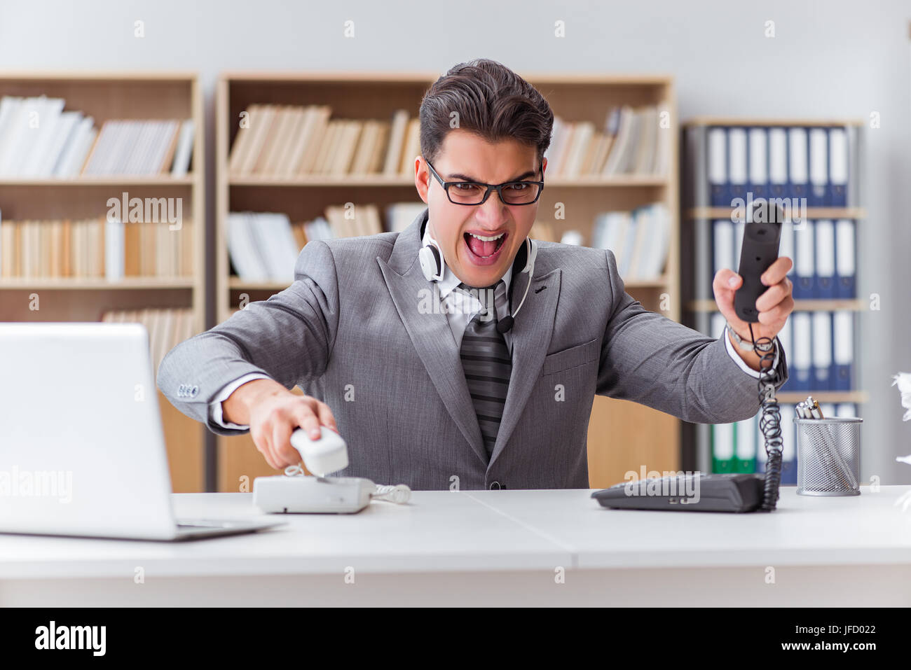 Angry helpdesk operator in the office Stock Photo - Alamy