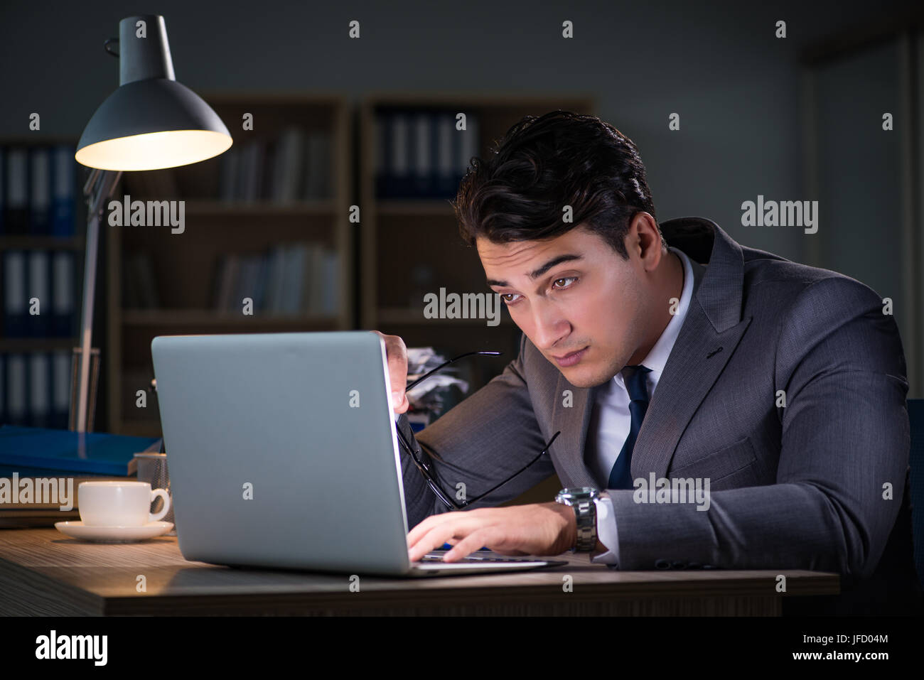 Man staying in the office for long hours Stock Photo - Alamy