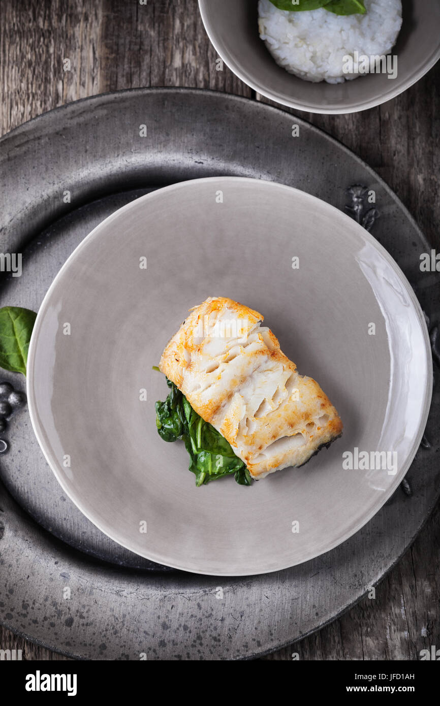 Fried cod fillets and spinach Stock Photo - Alamy