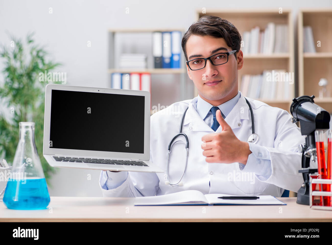 Young adult doctor with laptop computer Stock Photo - Alamy