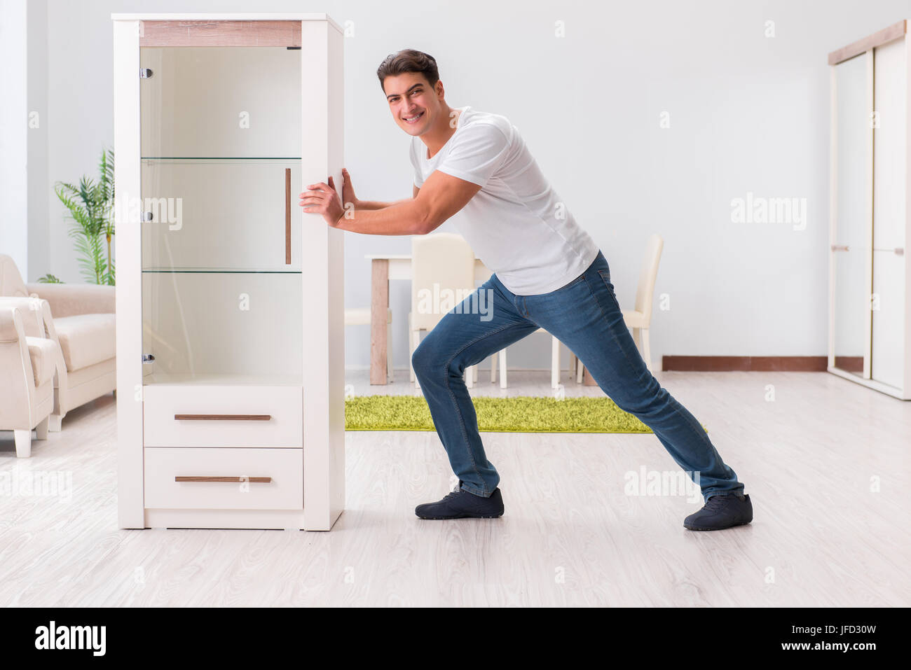 Man moving furniture at home Stock Photo - Alamy