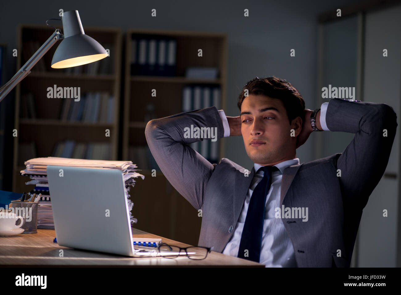 Man staying in the office for long hours Stock Photo - Alamy