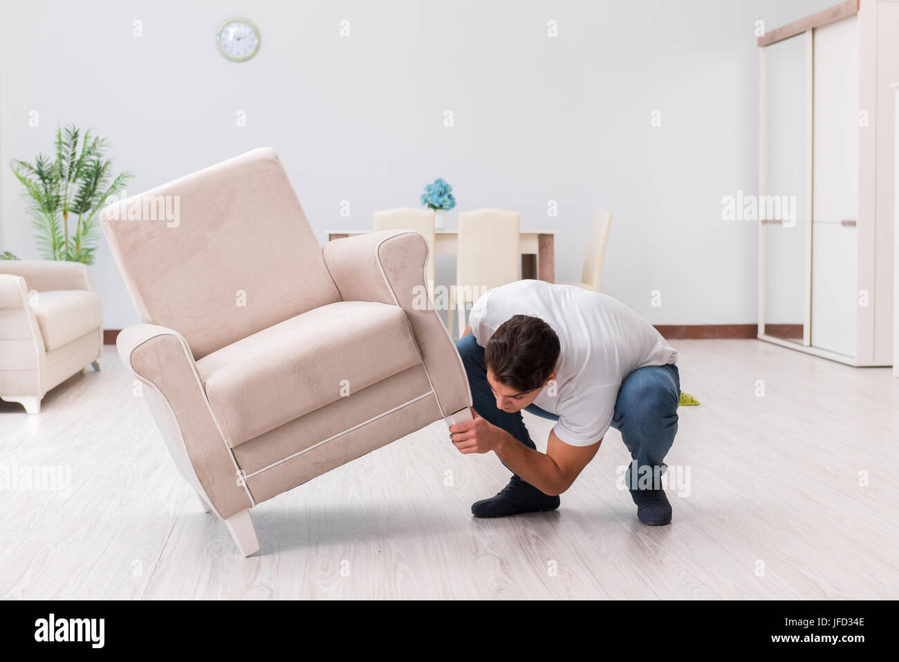 Man moving furniture at home Stock Photo - Alamy