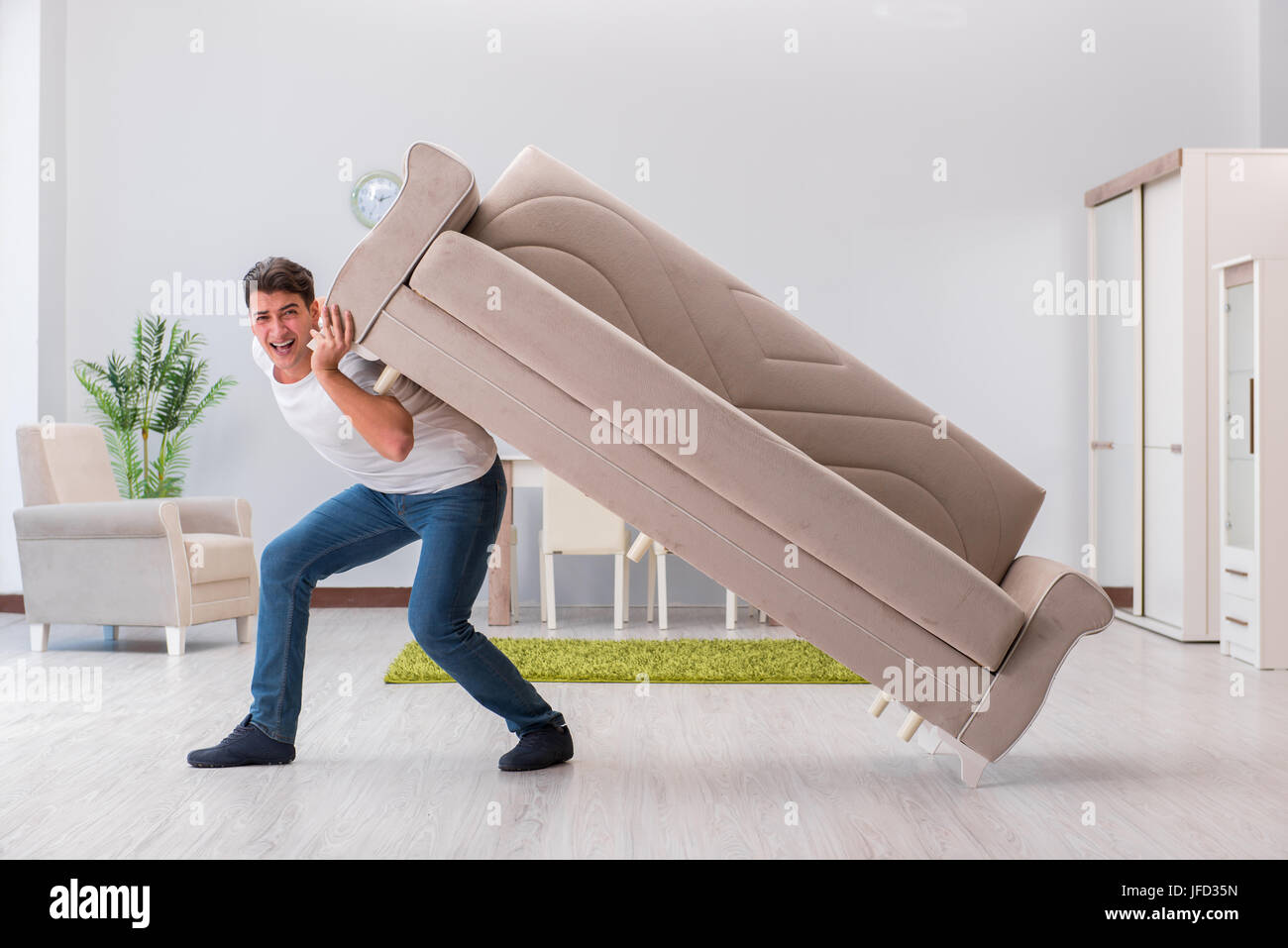Man moving furniture at home Stock Photo - Alamy
