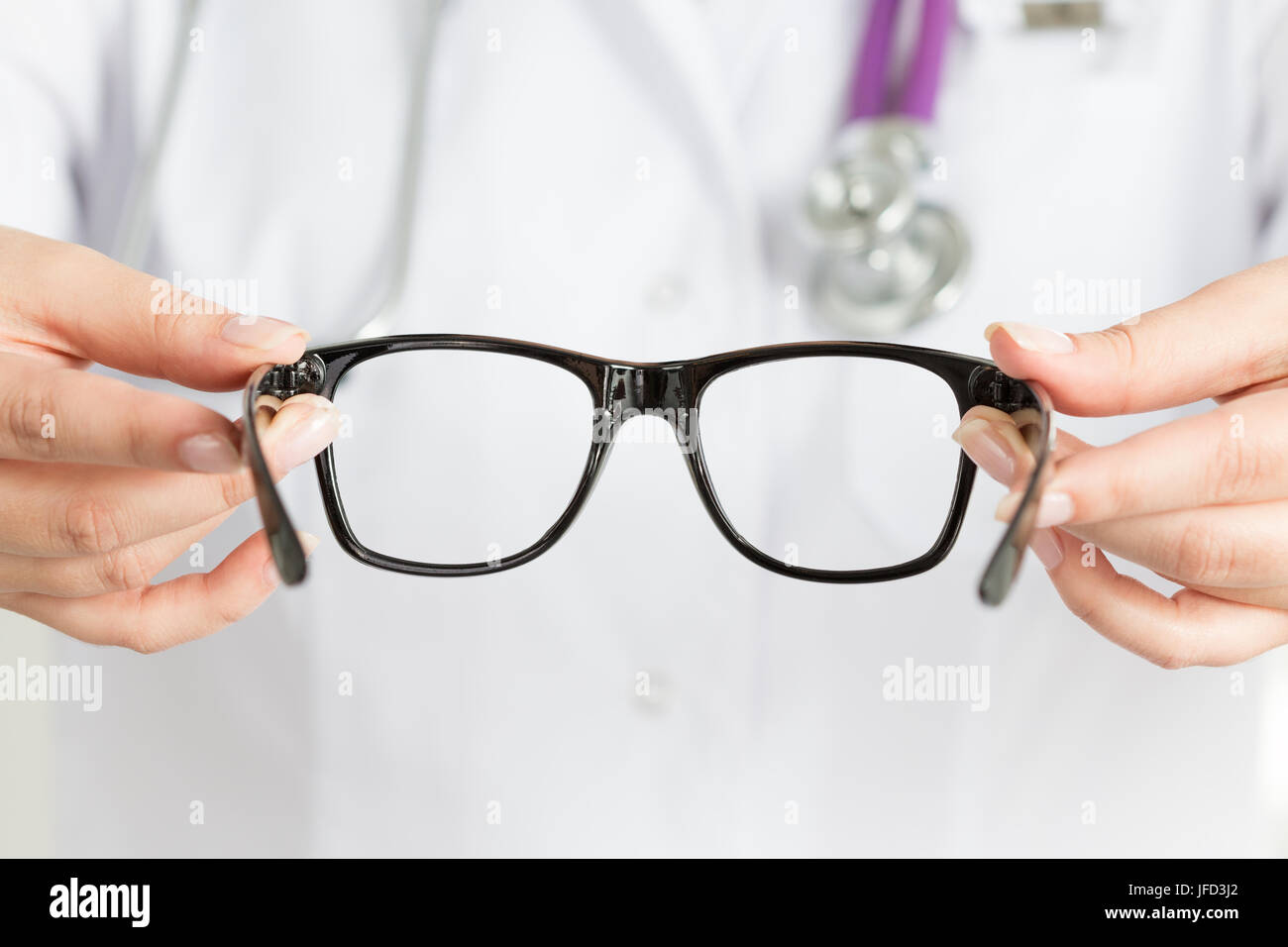 Female oculist doctor's hands giving a pair of black glasses. Good ...
