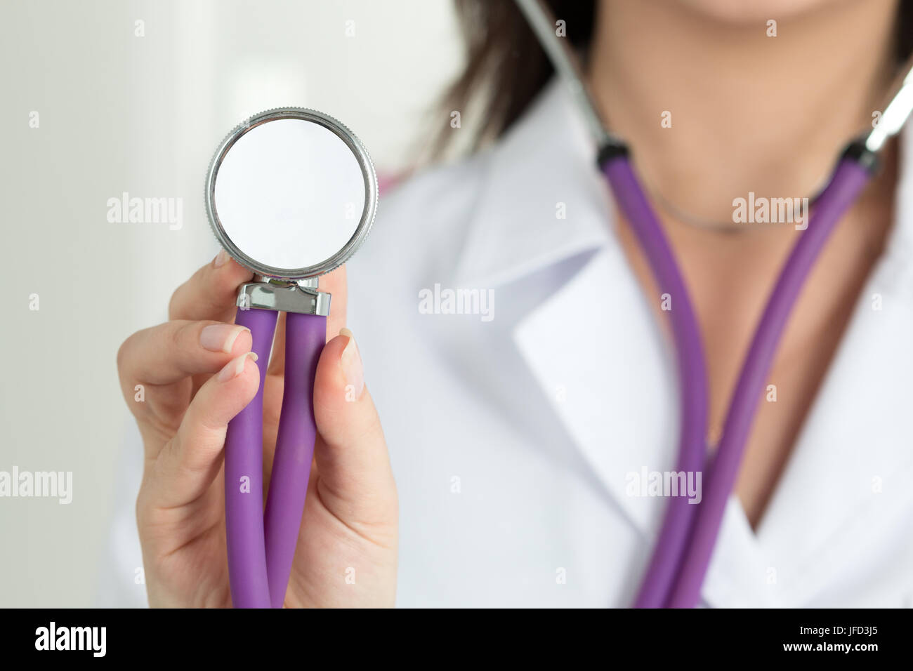 Doctors's hand holding stethoscope's head closeup. Medical help ...