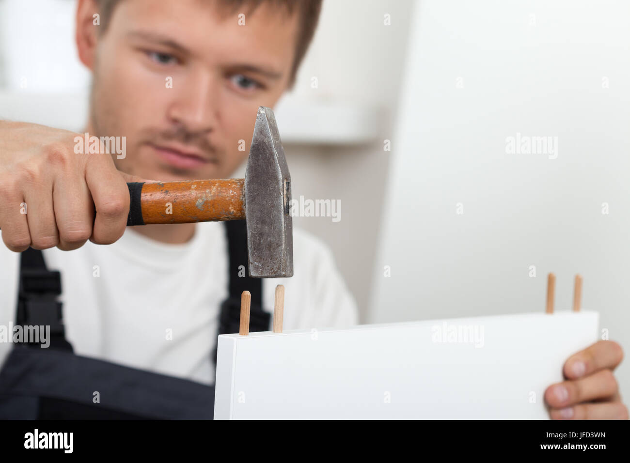 Man putting together self assembly furniture in new home close up. DIY ...