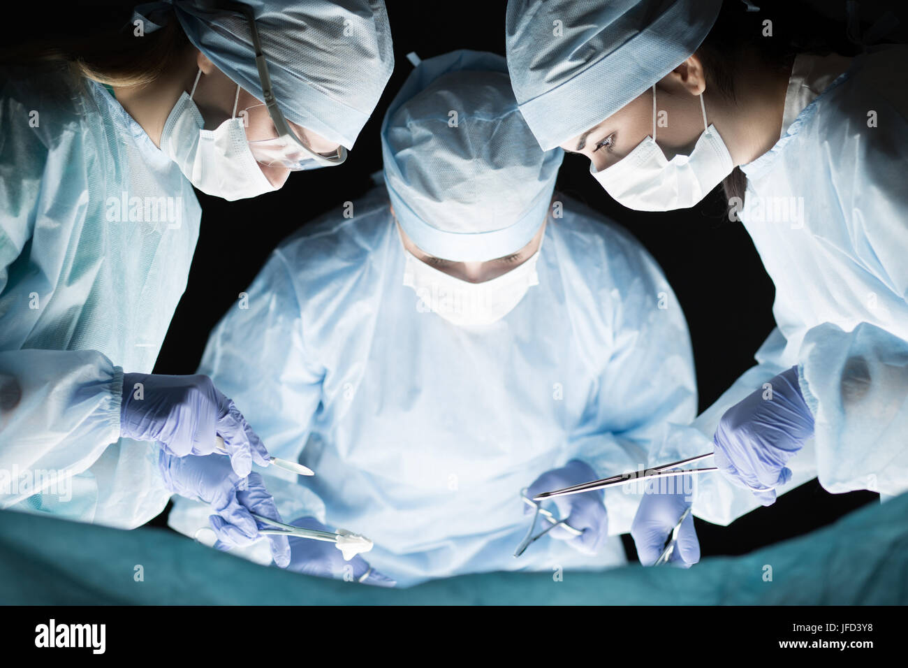 Medical team performing operation. Group of surgeon at work in ...