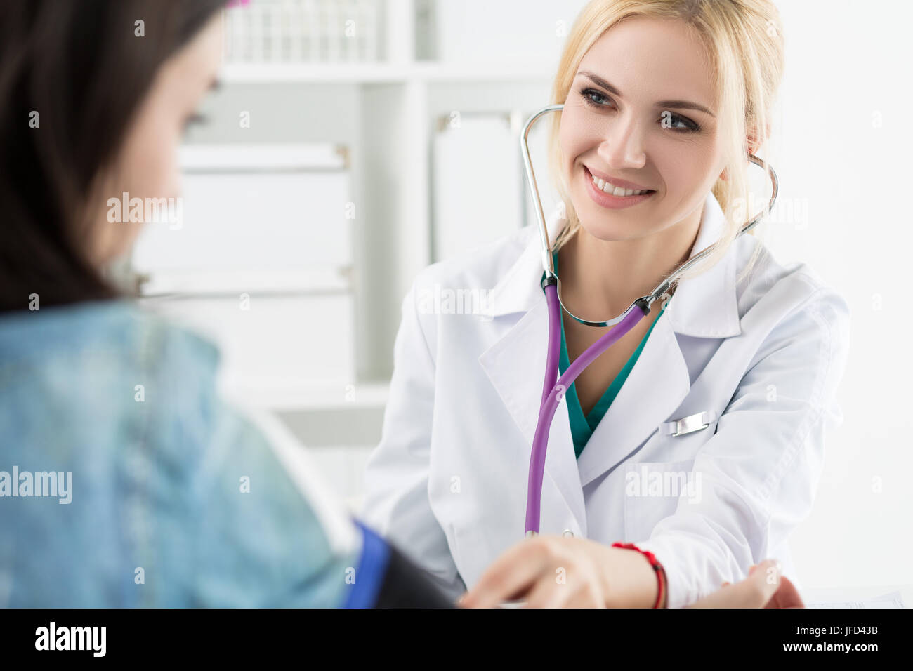 Beautiful smiling cheerful female medicine doctor measuring blood ...