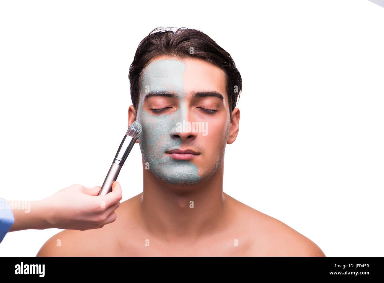 Man with face mask being applied on white Stock Photo - Alamy