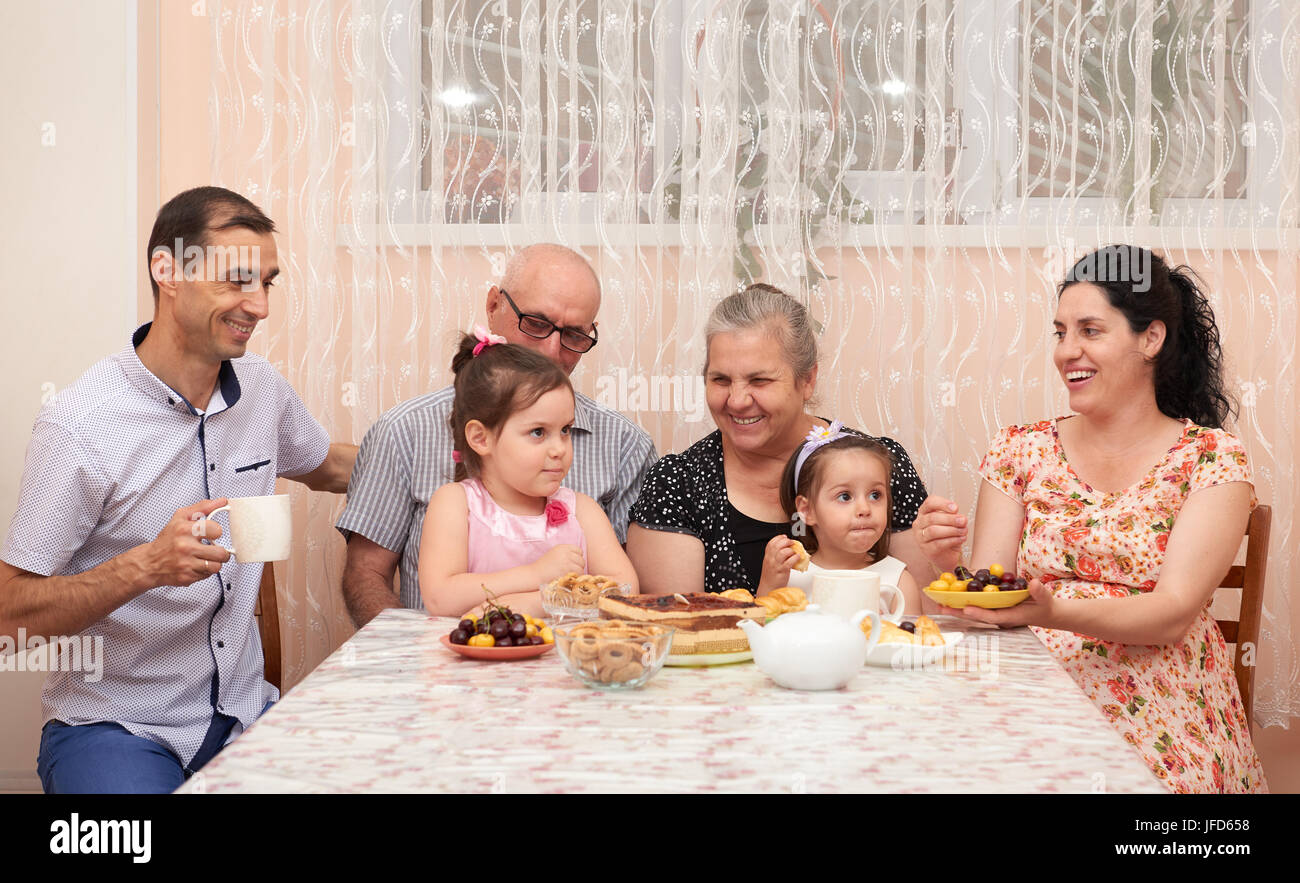 big family drinking tea in dining room Stock Photo - Alamy