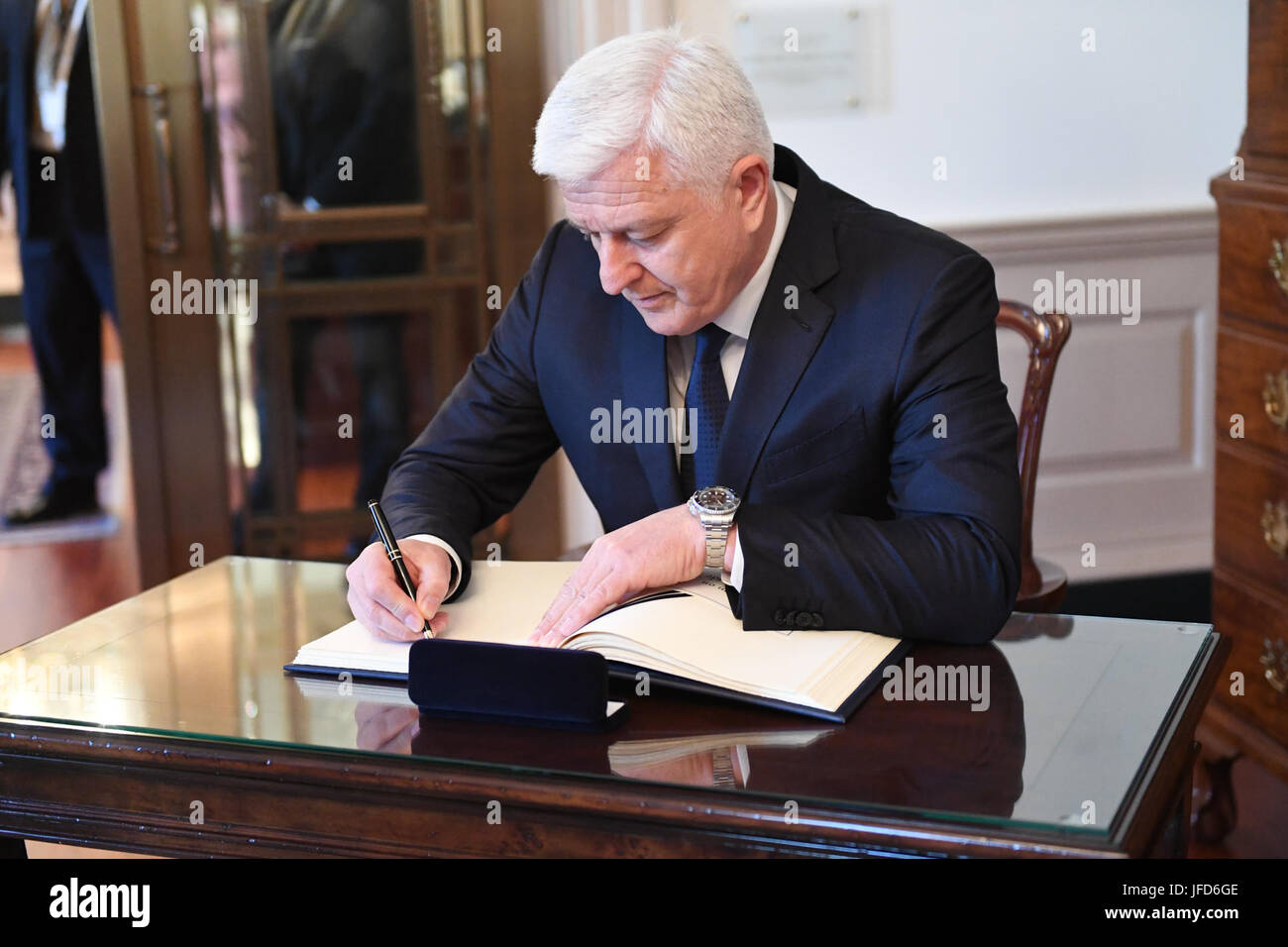 Montenegrin Prime Minister Dusko Markovic signs U.S. Secretary of State ...
