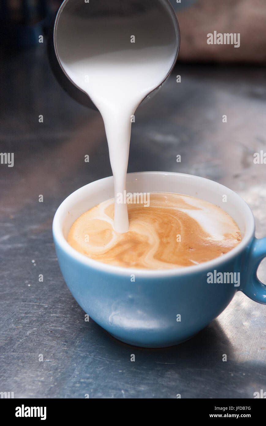 Making a coffee with hot milk pouring from the jug Stock Photo - Alamy