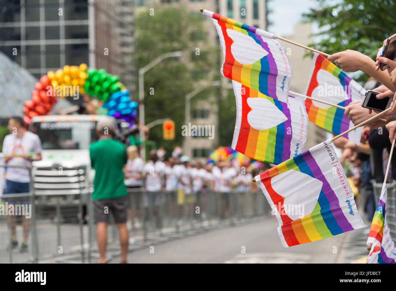 Toronto, Canada - 25 June 2017: Gay Pride Parade spectators holding gay ...