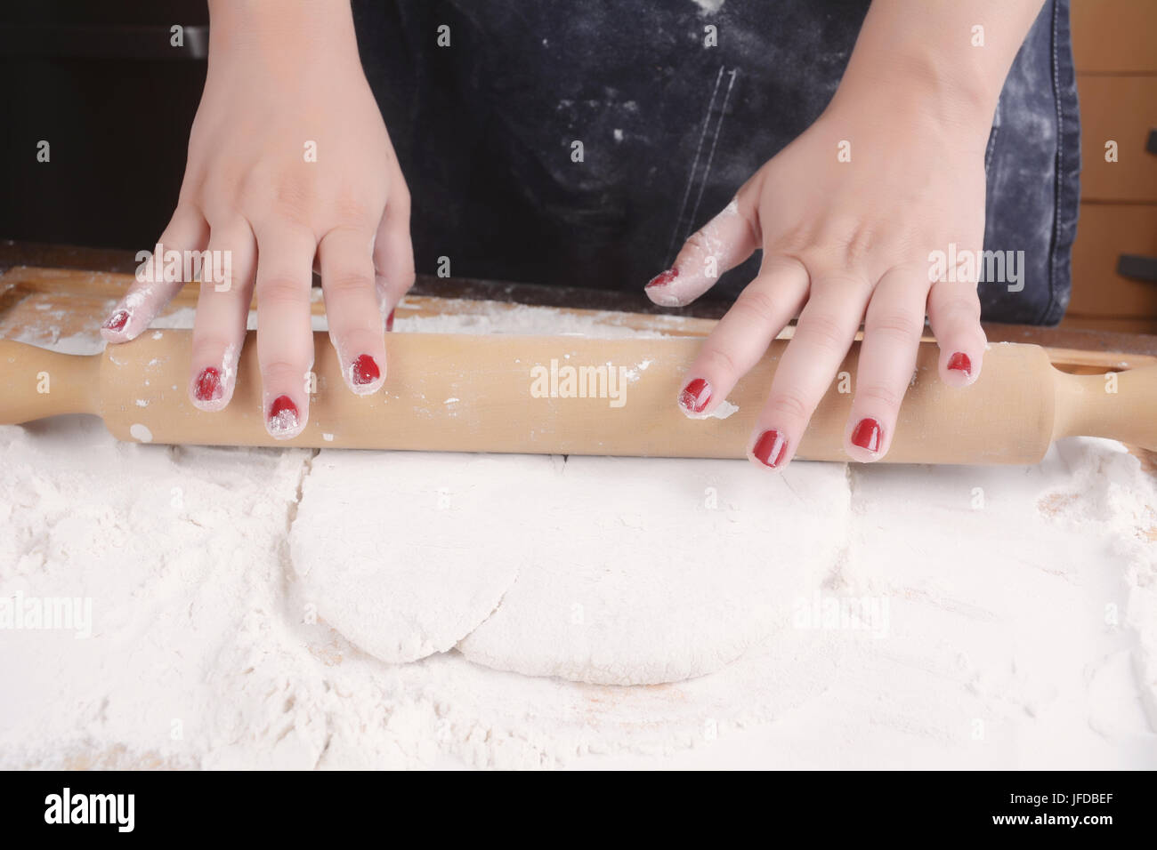 Close-up of woman rolling dough with rolling pin. Cooking concept Stock ...