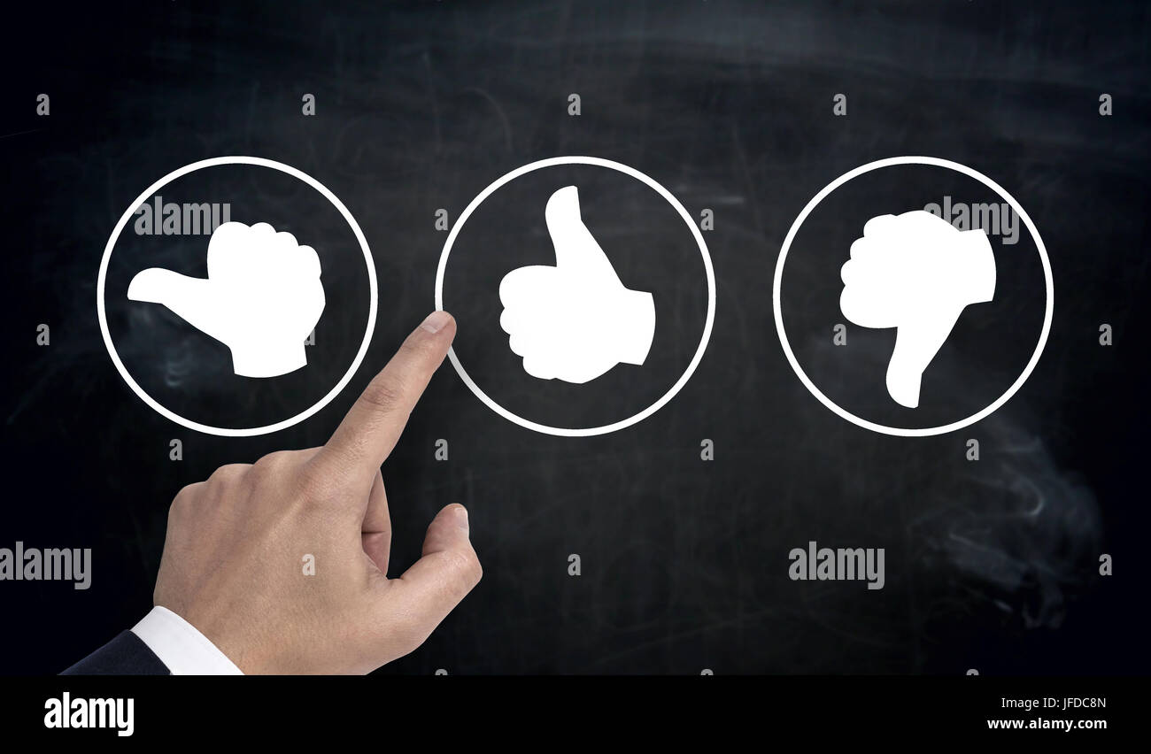 Hand pointing at rating icons with thumb Stock Photo - Alamy