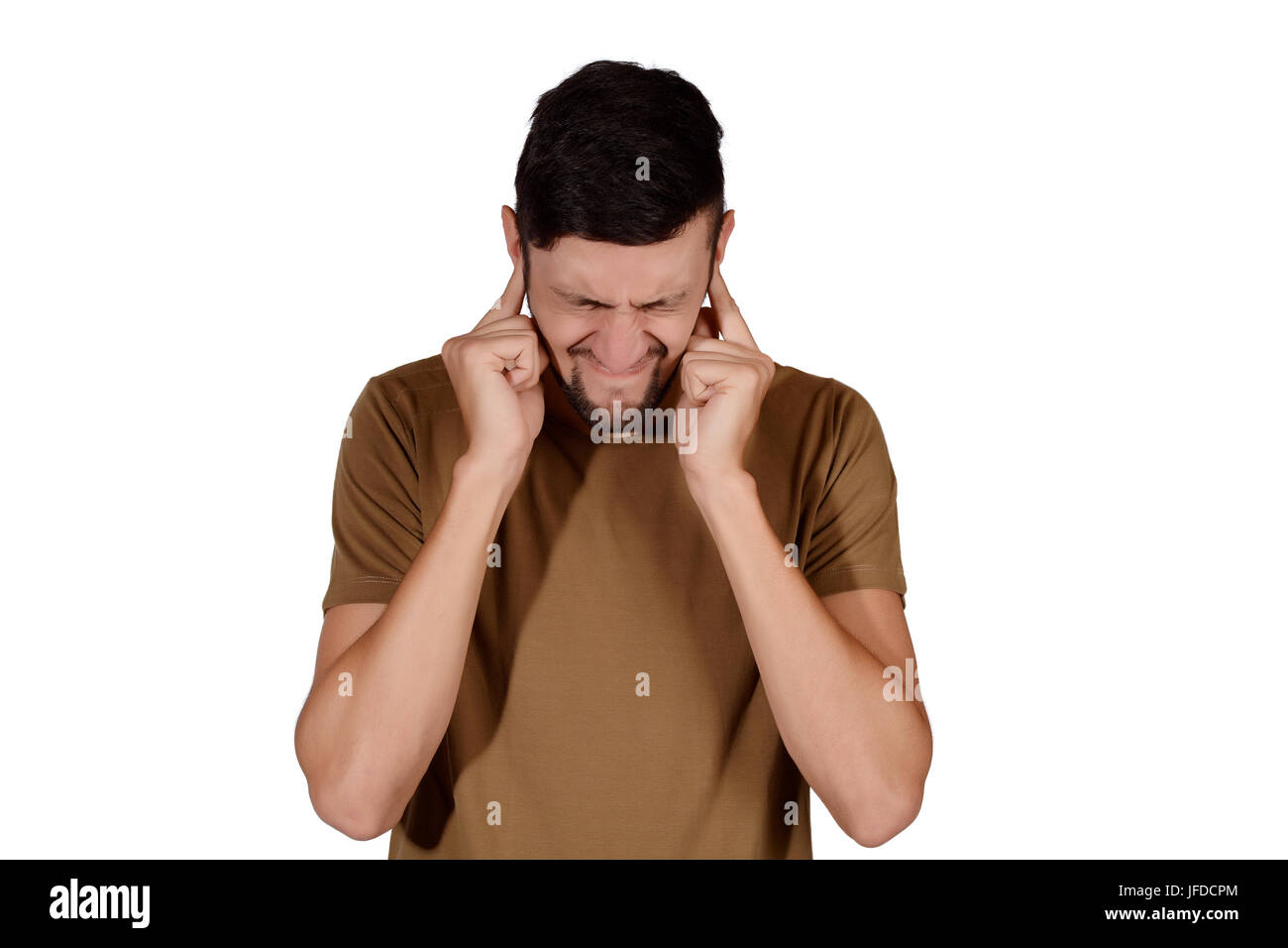 Portrait of a young man covering his ears. Isolated white background ...