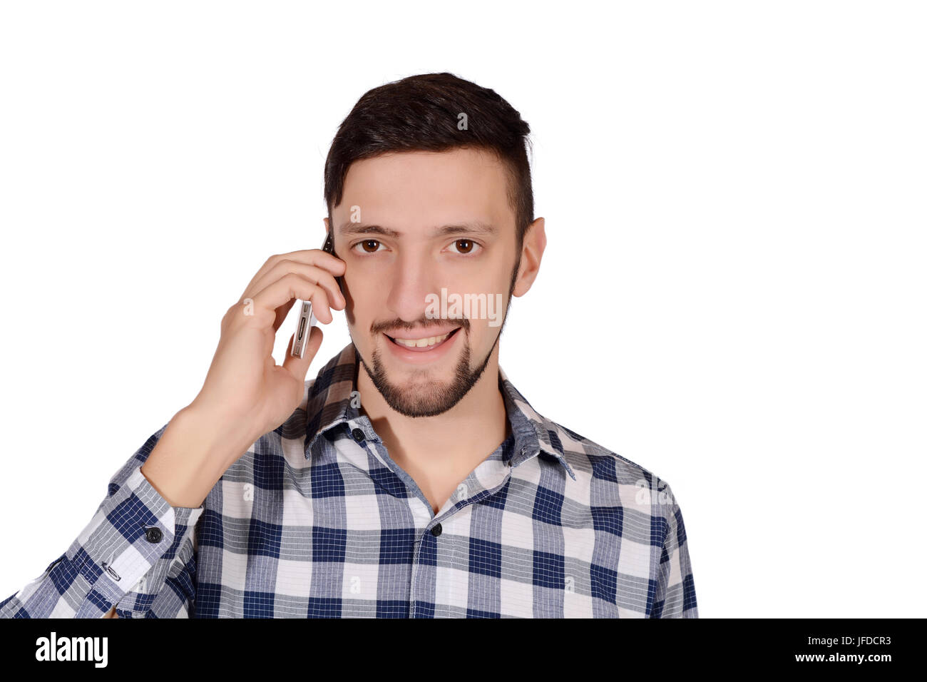 Portrait of a young handsome man talking on the phone. Isolated white ...