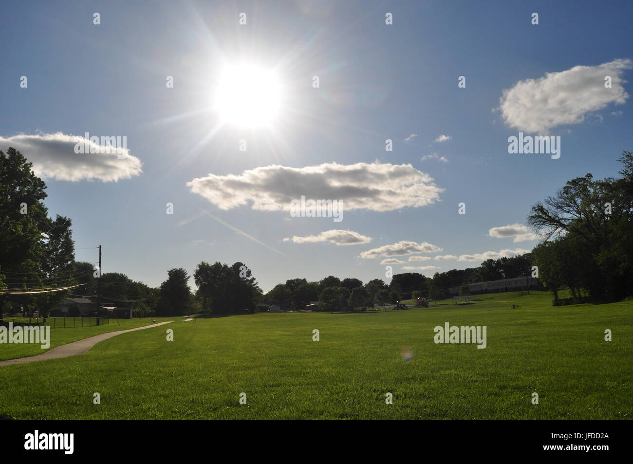 Scenic of sun clouds and grass Stock Photo - Alamy
