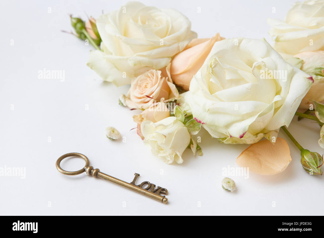 Red roses with key Stock Photo - Alamy