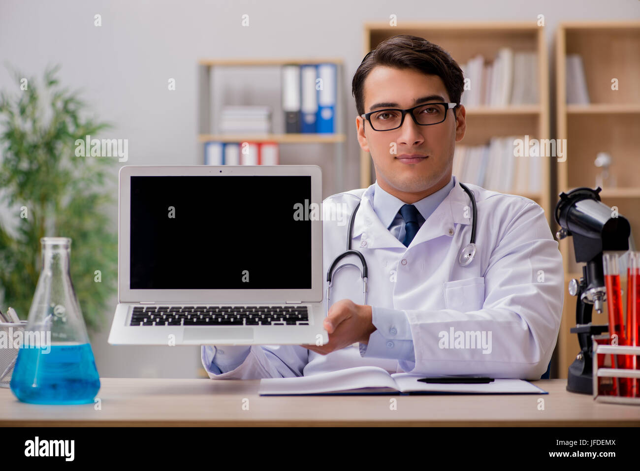 Young adult doctor with laptop computer Stock Photo - Alamy