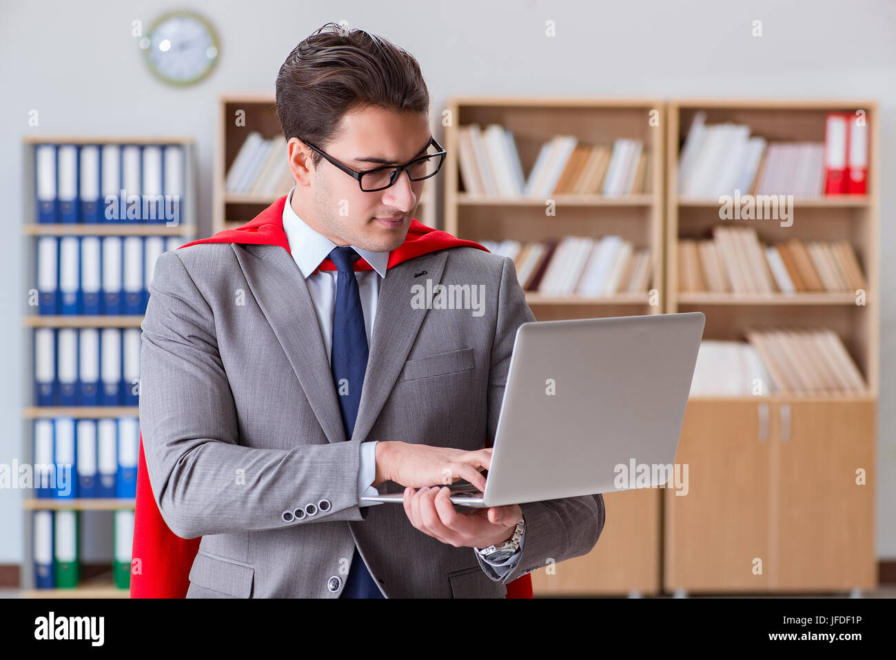 Superhero businessman working in the office Stock Photo - Alamy