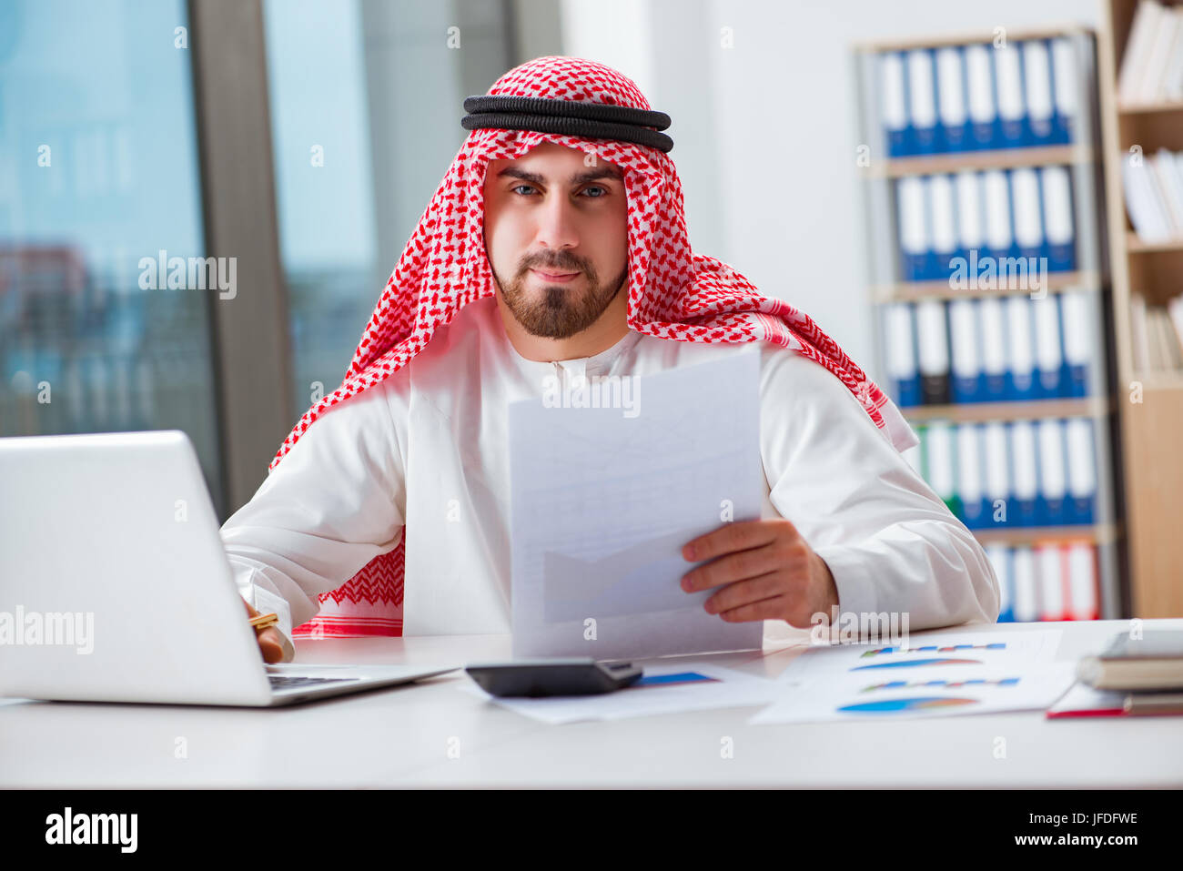 Arab businessman working on laptop computer Stock Photo - Alamy