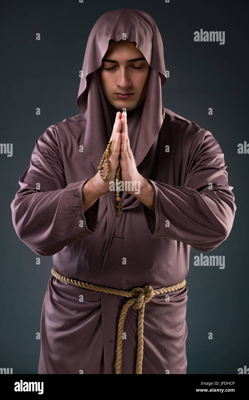 Monk in religious concept on gray background Stock Photo - Alamy