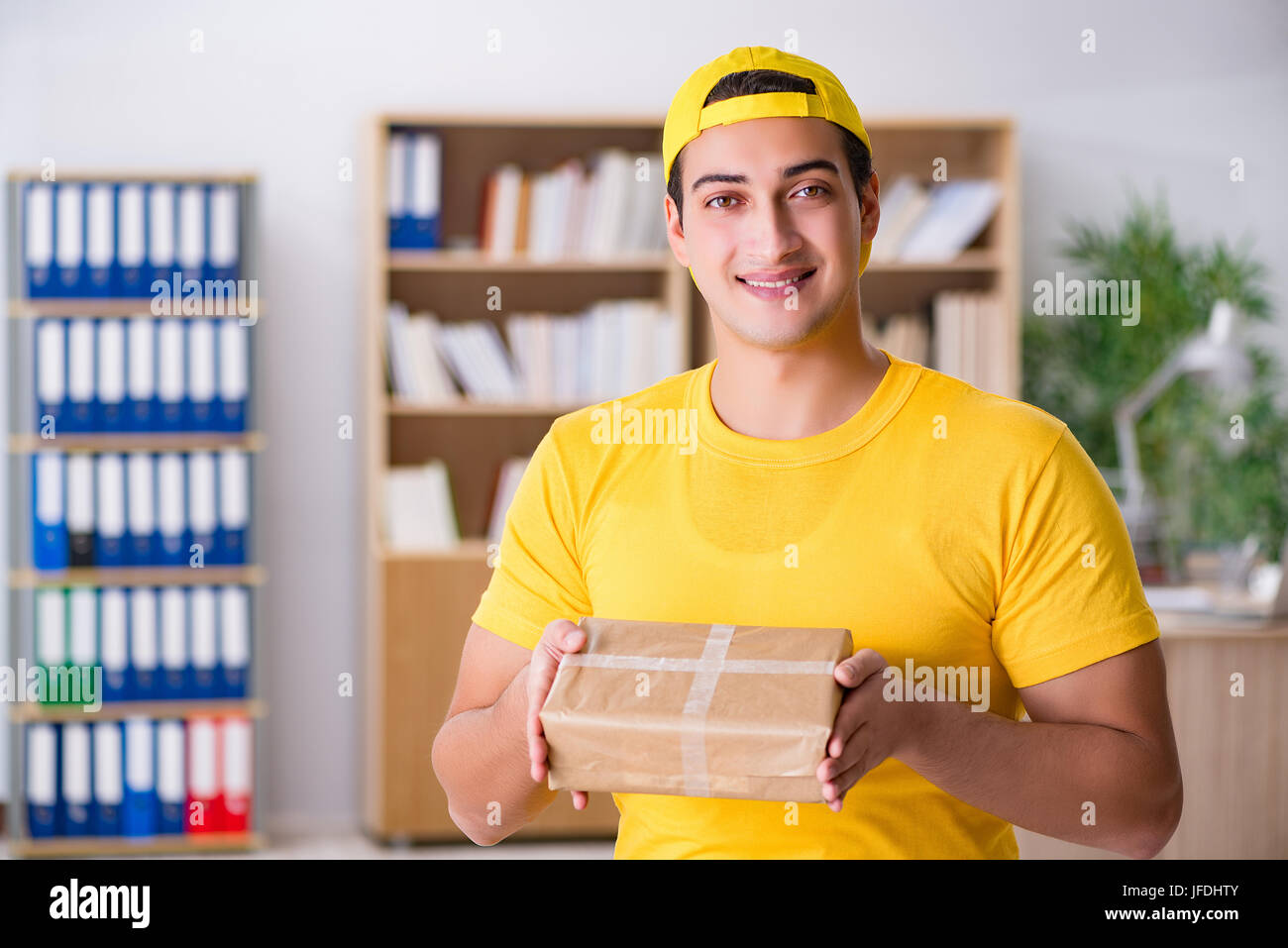 Delivery man delivering parcel box Stock Photo - Alamy