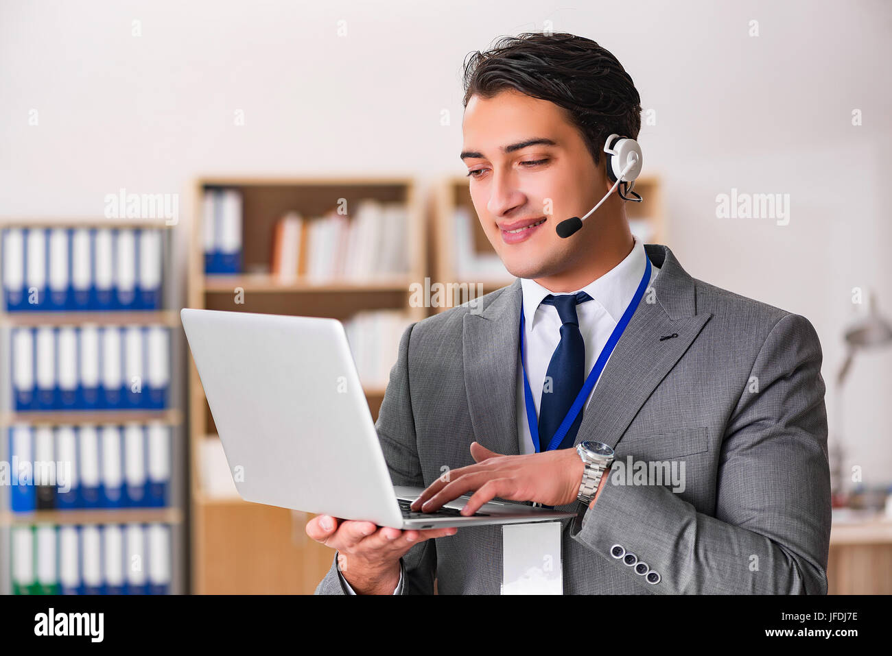Handsome customer service clerk with headset Stock Photo - Alamy